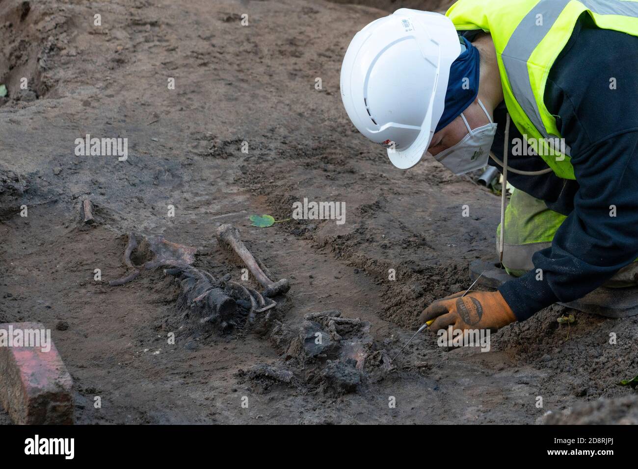 Archeologist working to remove human remains from historic cemetery on ...
