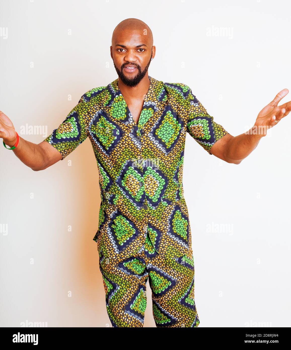portrait of young handsome african man wearing bright green national ...