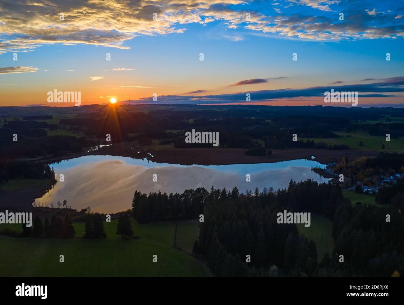 Aerial photo of sunset behind lake ELBSEE in Aitrang, Bavaria, Germany ...