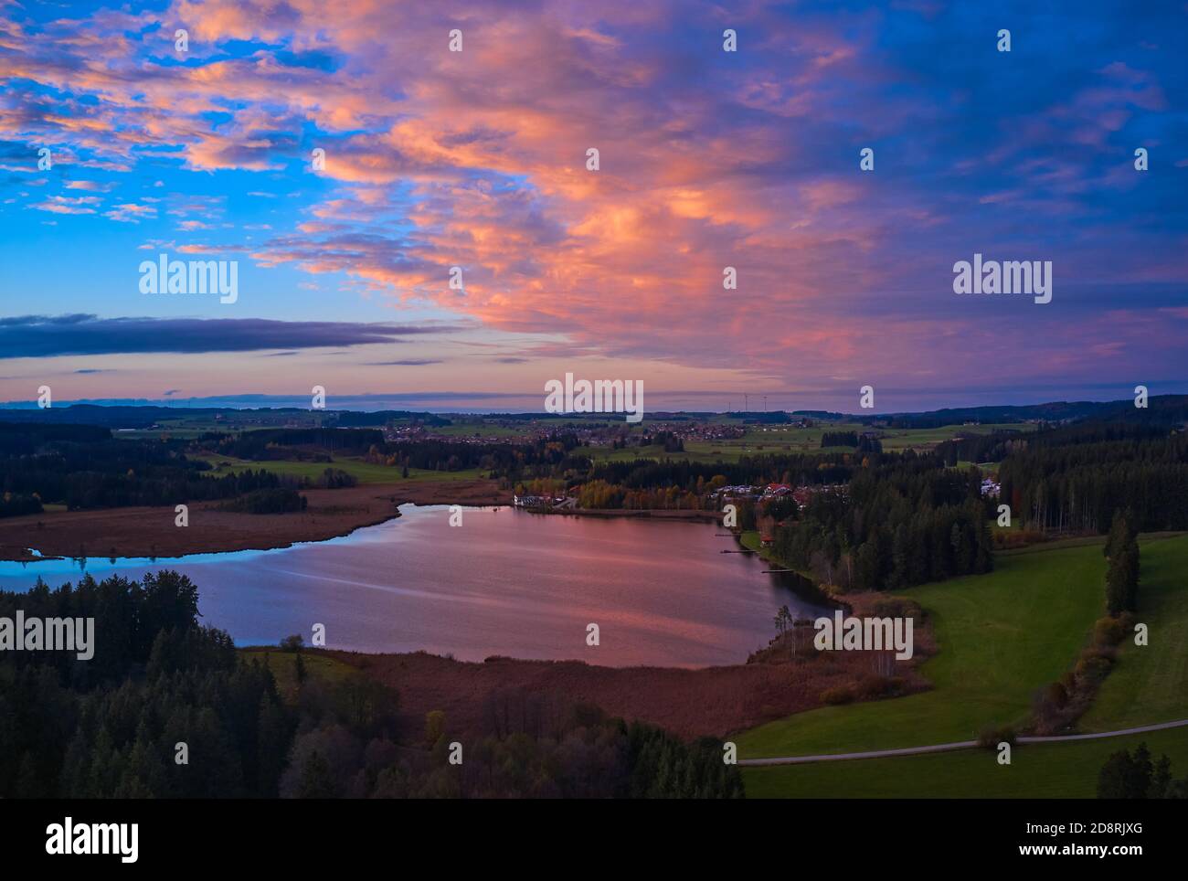 Aerial photo of sunset behind lake ELBSEE in Aitrang, Bavaria, Germany ...