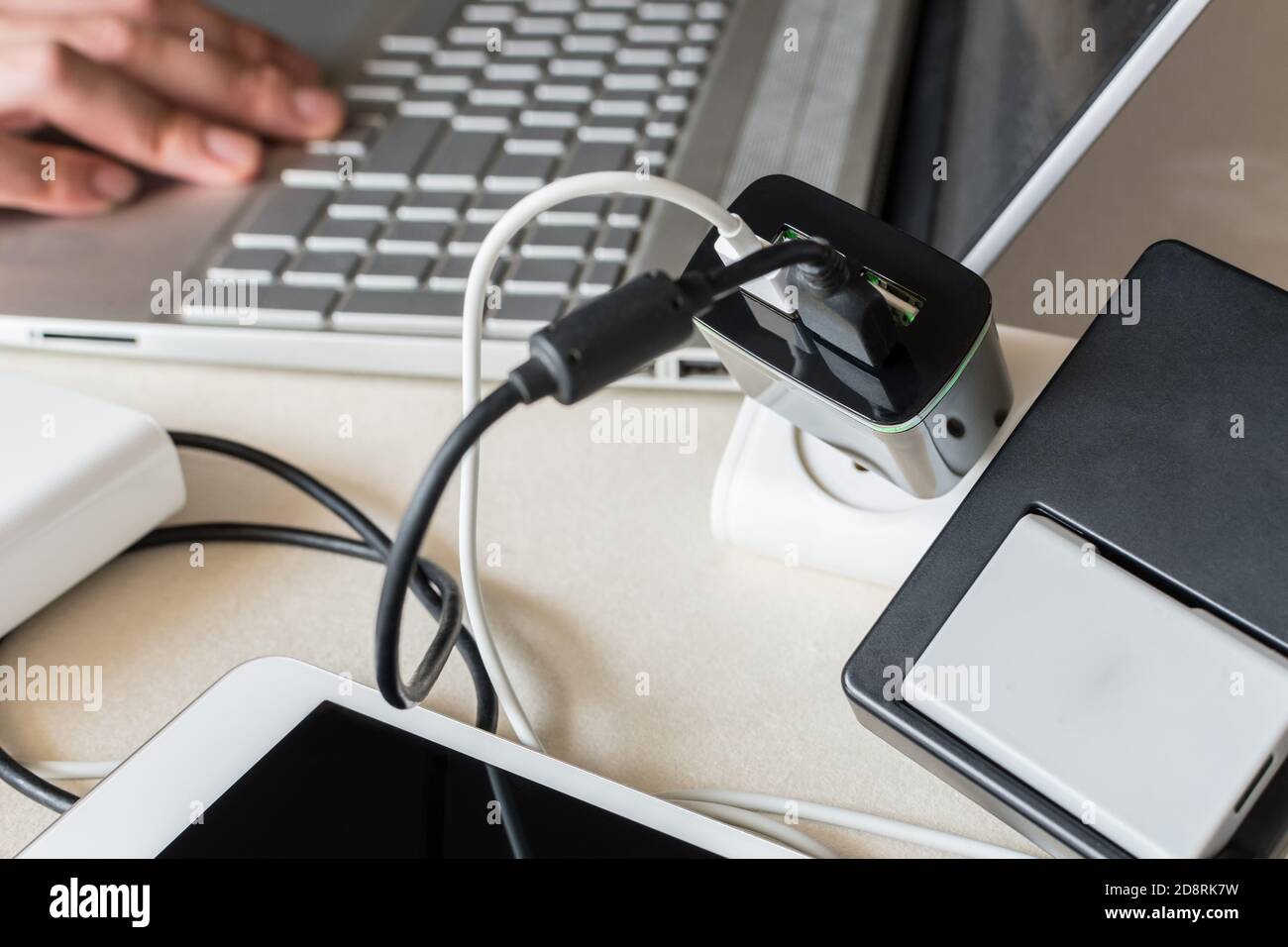 Electrical USB charger plug for four USB cable on a desk. Battery ...