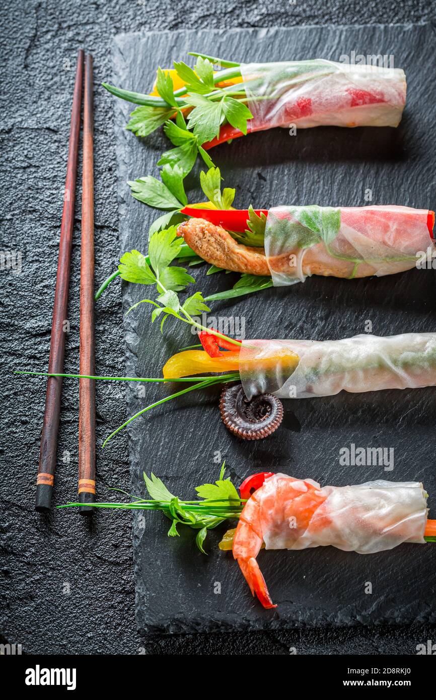 Homemade spring rolls made of fresh vegetables on black rock Stock ...