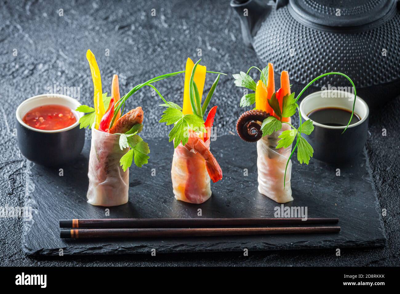 Healthy spring rolls made of fresh vegetables on black rock Stock Photo ...