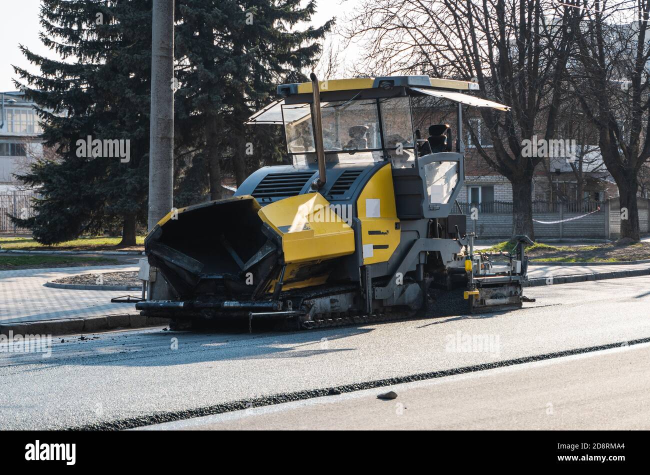 Industrial asphalt paver machine laying fresh asphalt on road ...