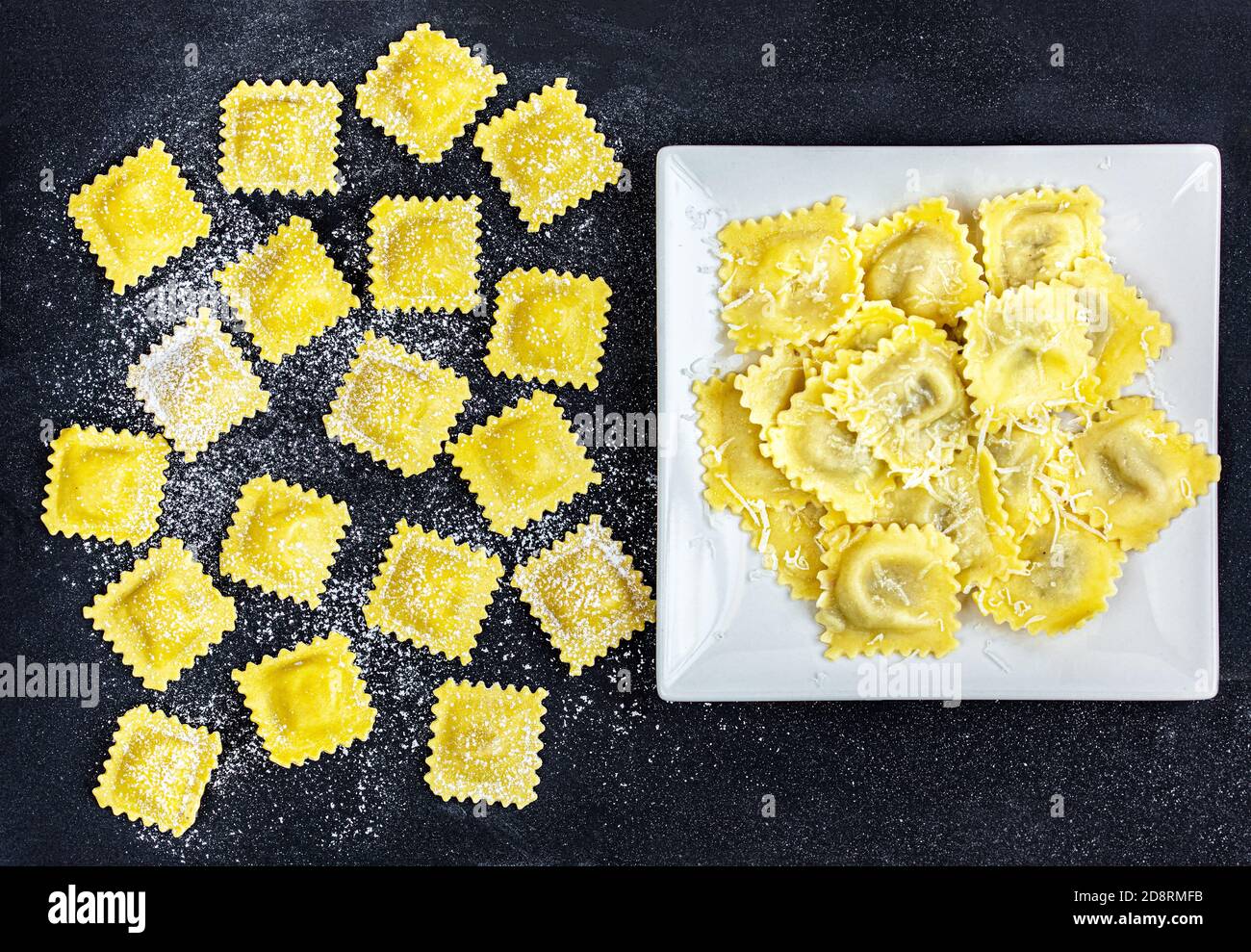 Ravioli with flour and basil on black background. Italian ravioli ...