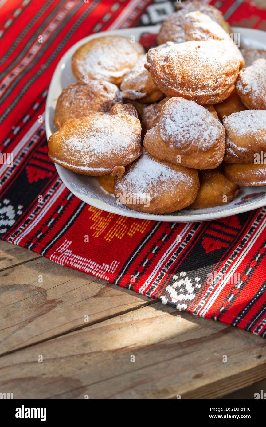romanian mini doughnuts on a plate on red traditional cloth Stock Photo ...