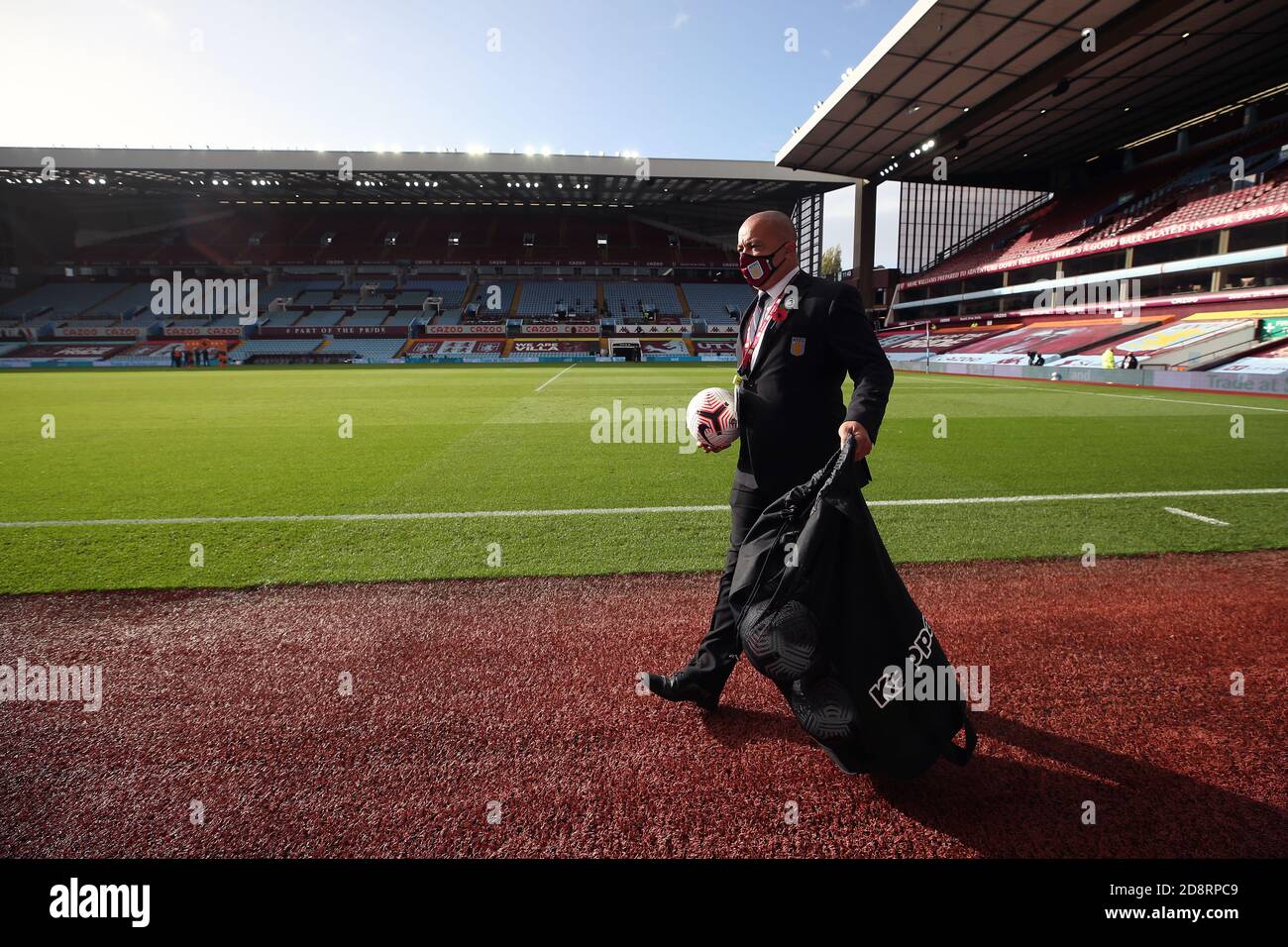 An Aston Villa official carries out the match balls during the Premier ...