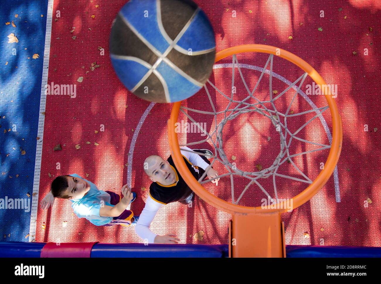 Brothers playing basketball One On One. Shooting at the basket and ...