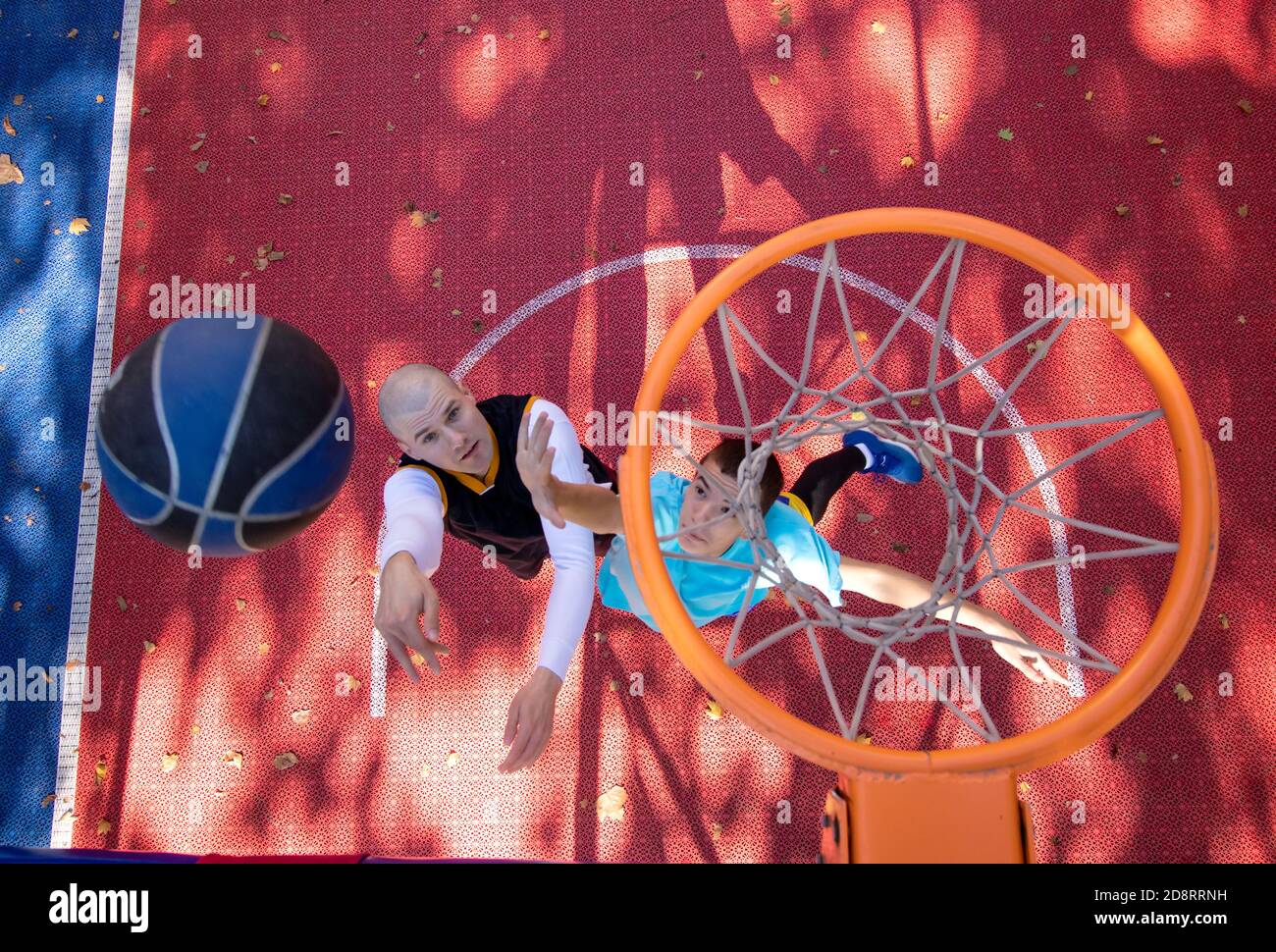 Brothers playing basketball One On One. Shooting at the basket and ...