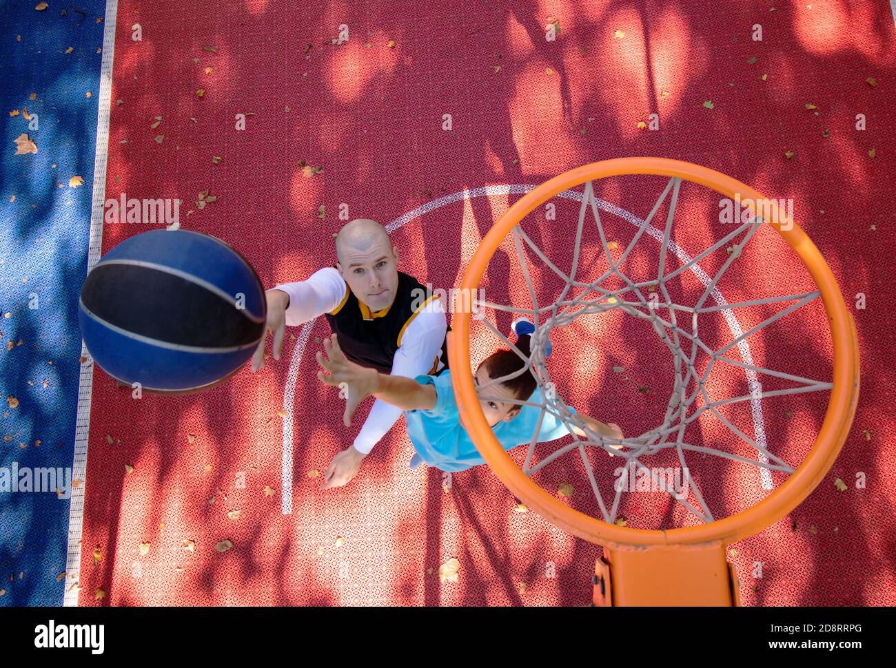 Brothers playing basketball One On One. Shooting at the basket and ...