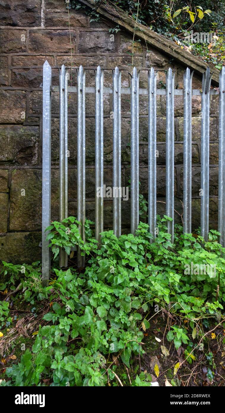Galvanised steel palisade spiked security fencing on railway banks ...