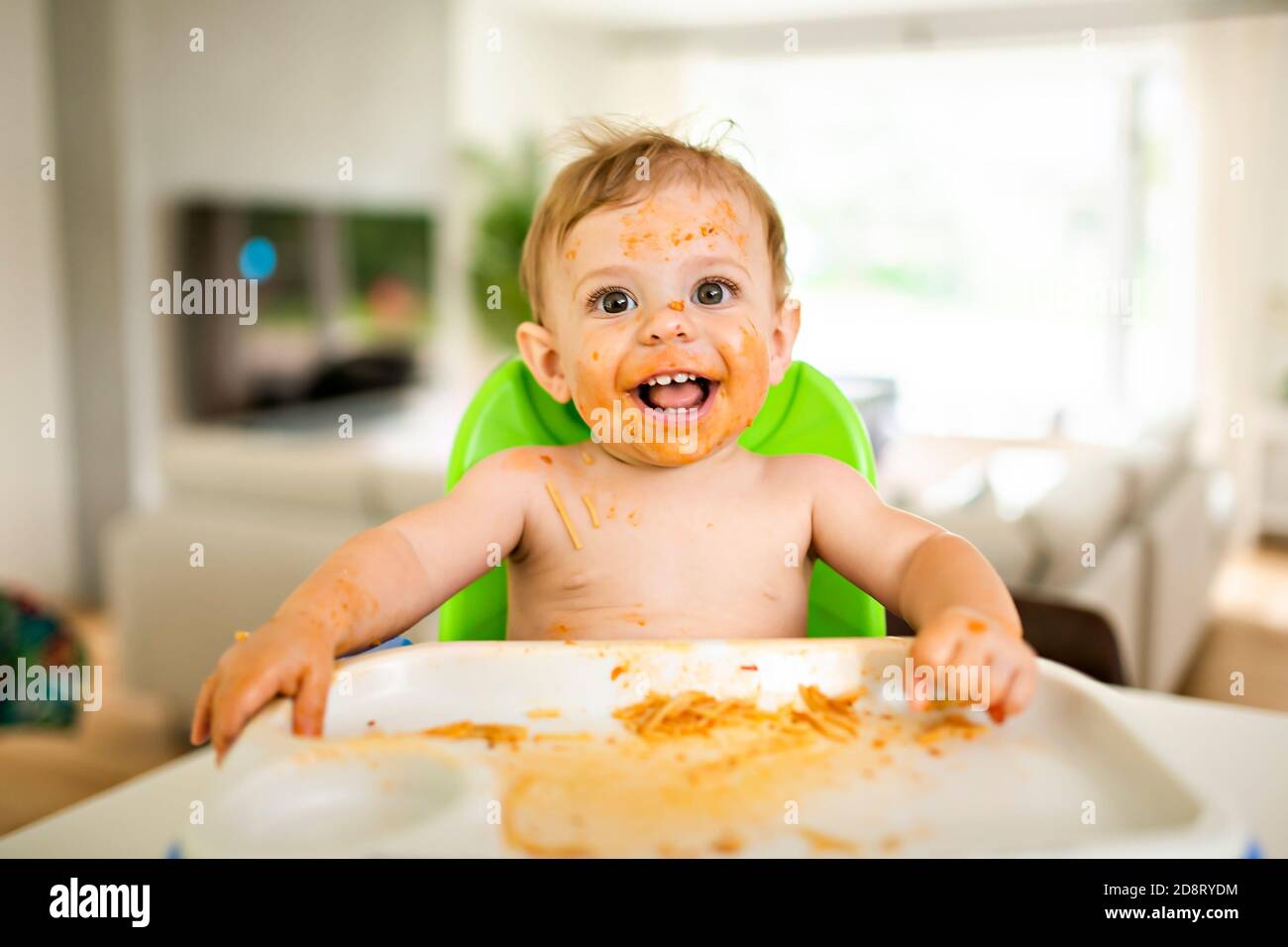 A Little baby eating her dinner and making a mess Stock Photo - Alamy