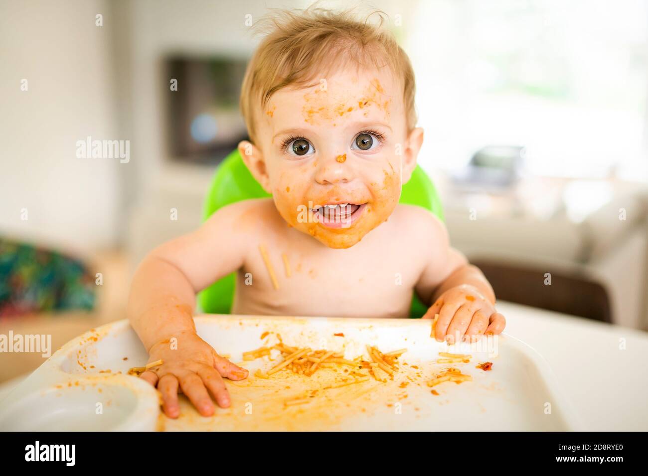 A Little baby eating her dinner and making a mess Stock Photo - Alamy