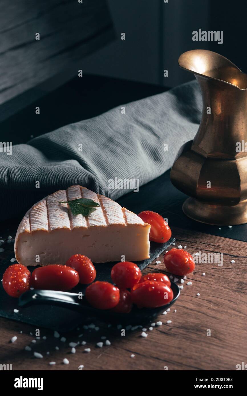 Closeup of the traditional French Brie cheese with fresh tomatoes Stock ...