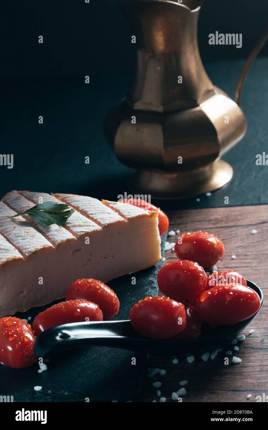 Closeup of the traditional French Brie cheese with fresh tomatoes Stock ...