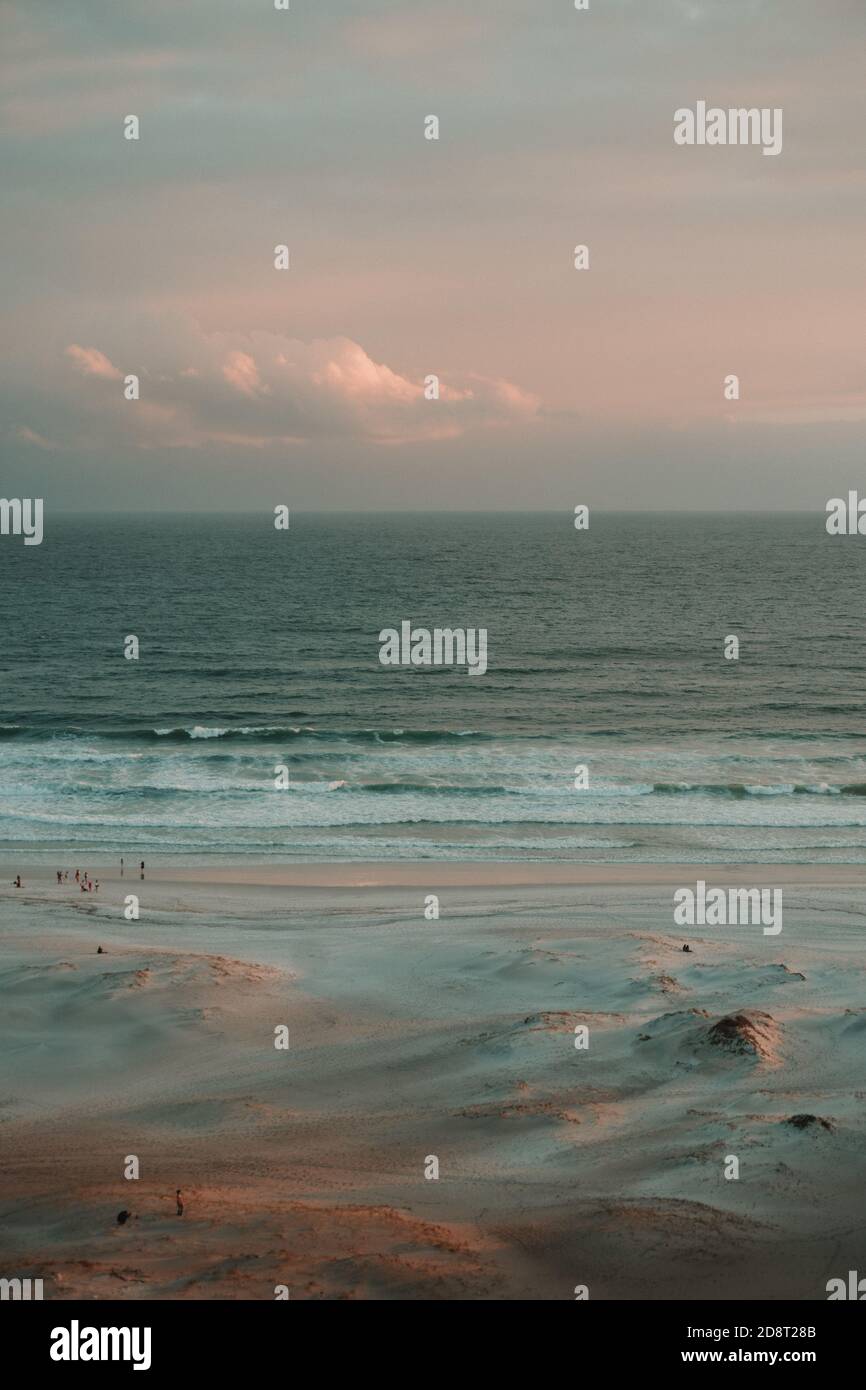 Aerial view of the wavy ocean hitting the sandy beach in Rio de Janeiro ...