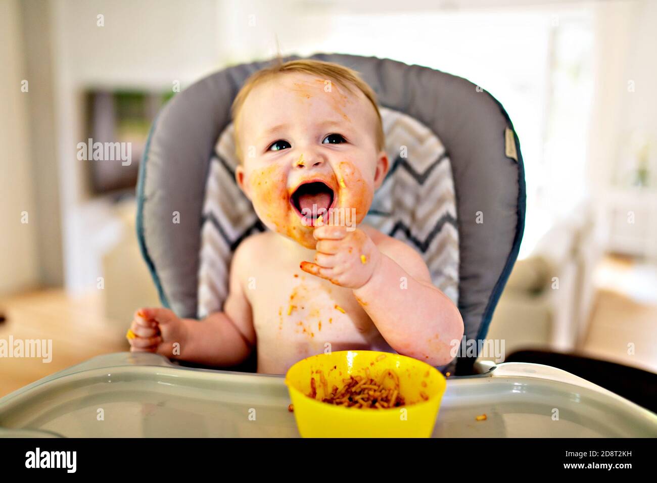 A Little baby eating her dinner and making a mess Stock Photo - Alamy