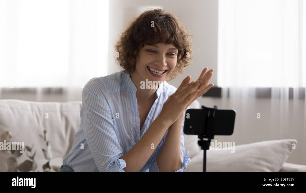 Close up overjoyed young woman recording video, using phone Stock Photo ...