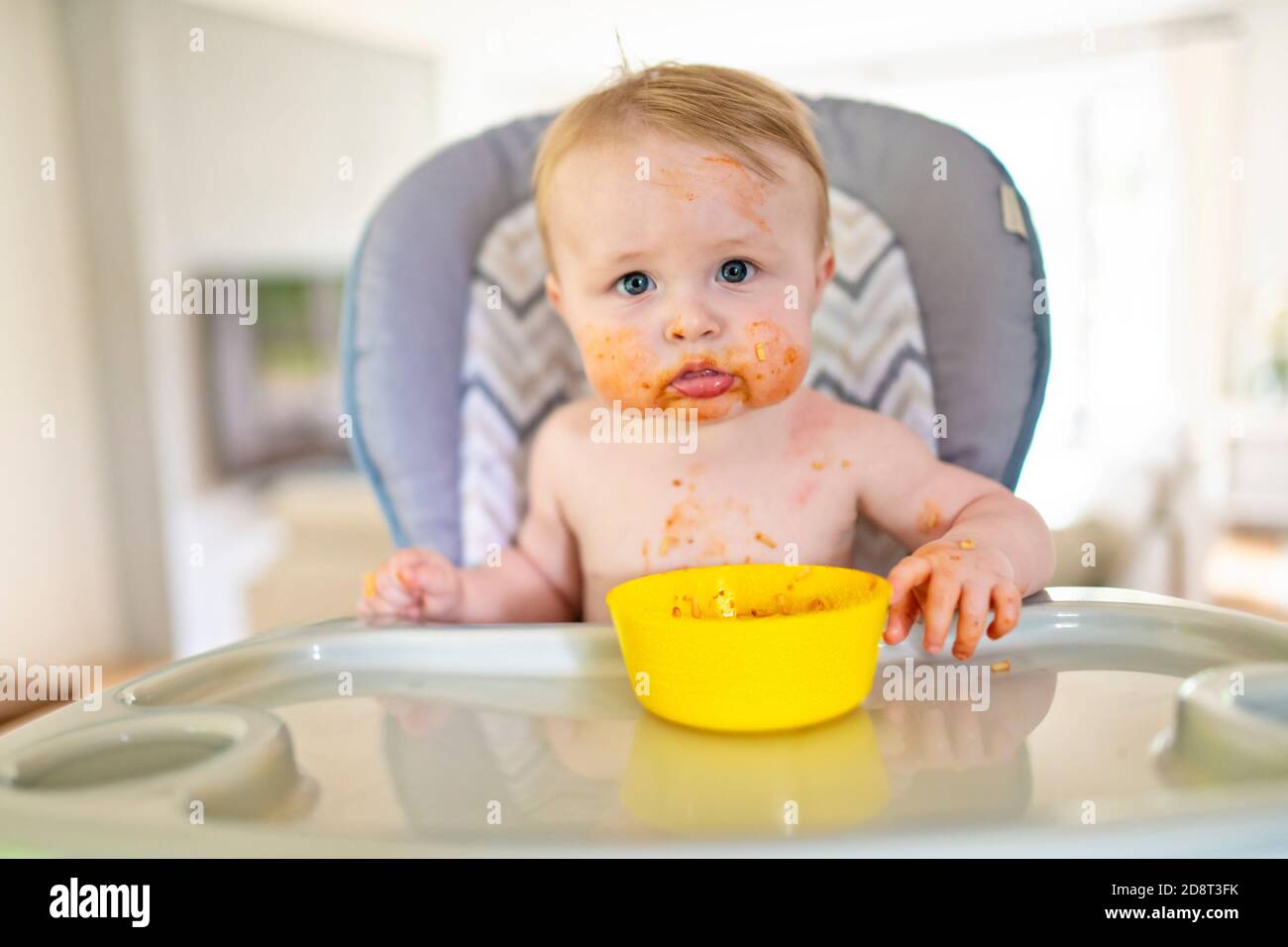 A Little baby eating her dinner and making a mess Stock Photo - Alamy