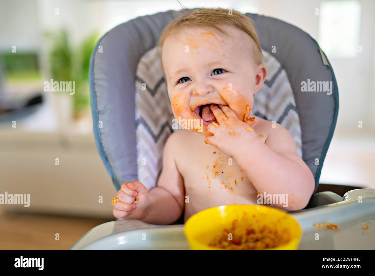A Little baby eating her dinner and making a mess Stock Photo - Alamy