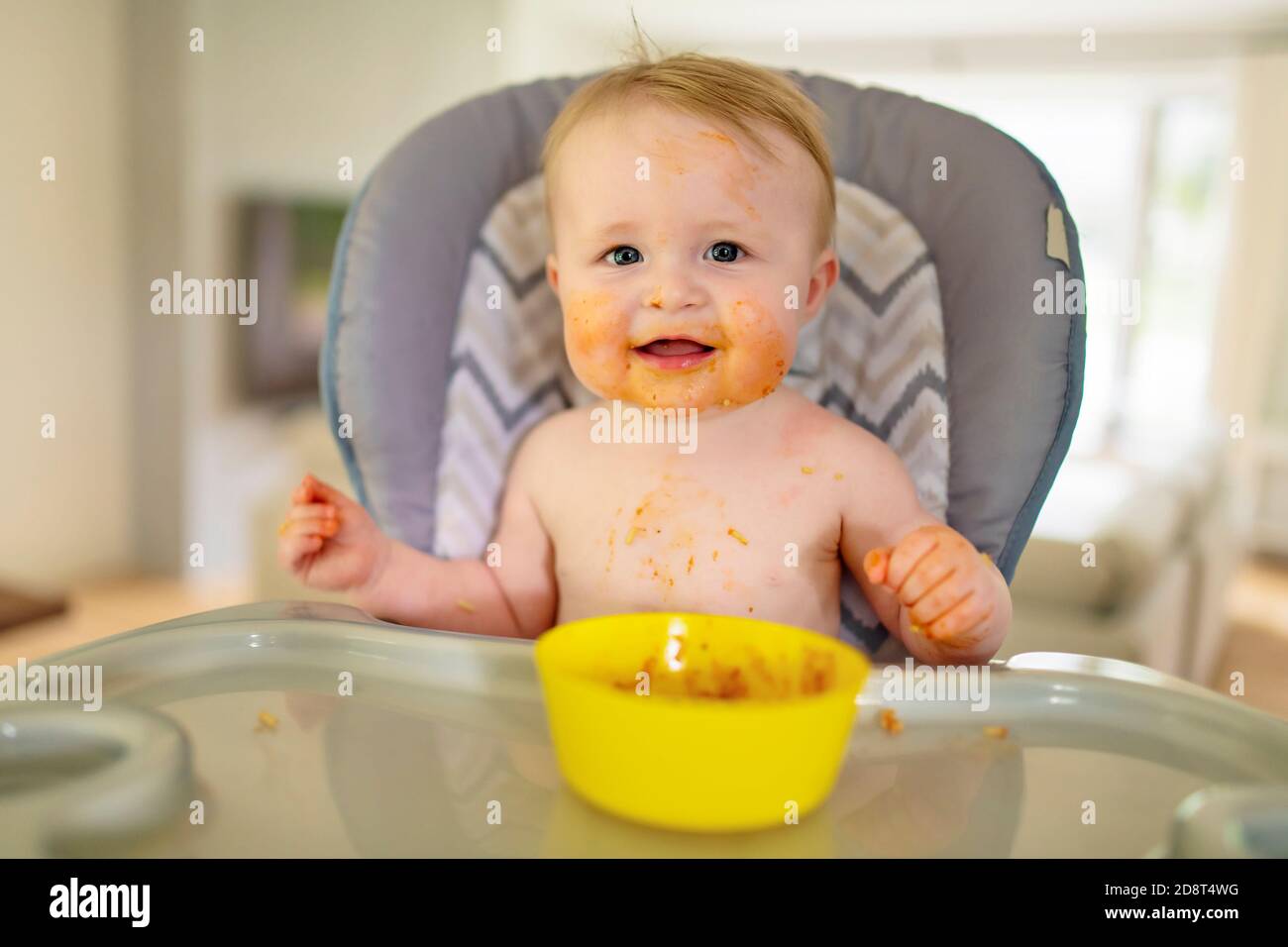 A Little baby eating her dinner and making a mess Stock Photo - Alamy