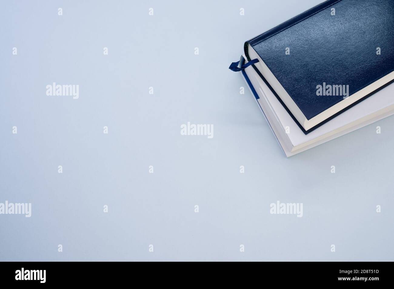 Closeup top view shot of blue and white books isolated light blue ...