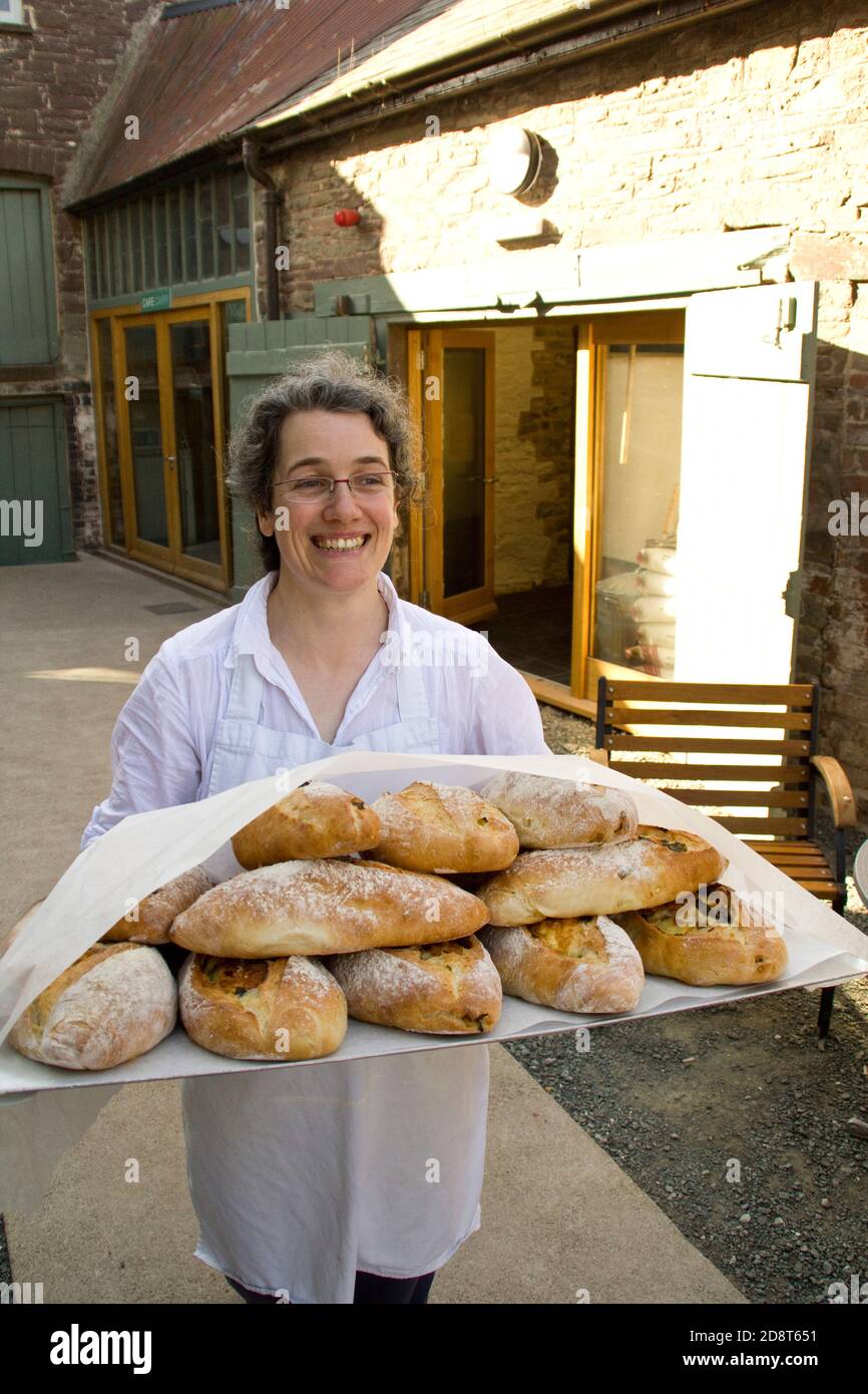 Female Baker with loaves of fresshly made artisan bread Stock Photo - Alamy