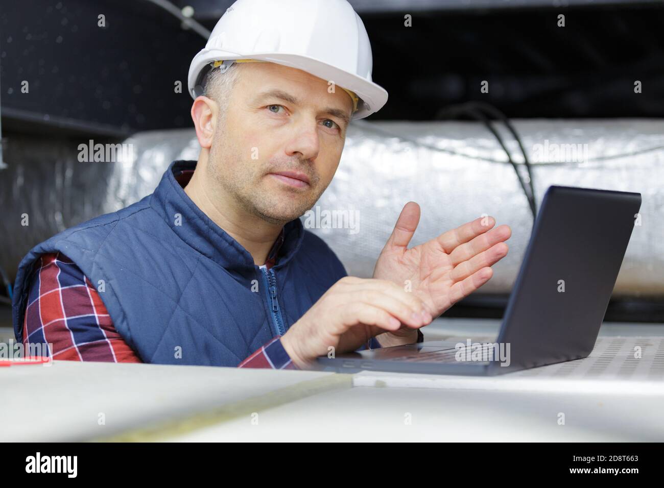 electrical worker testing wire with laptop Stock Photo - Alamy