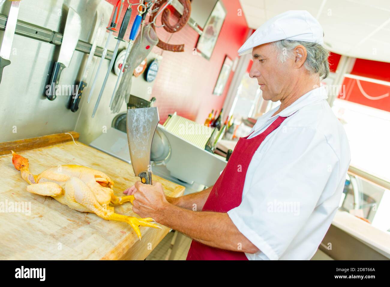 a butcher preparing a chicken Stock Photo - Alamy