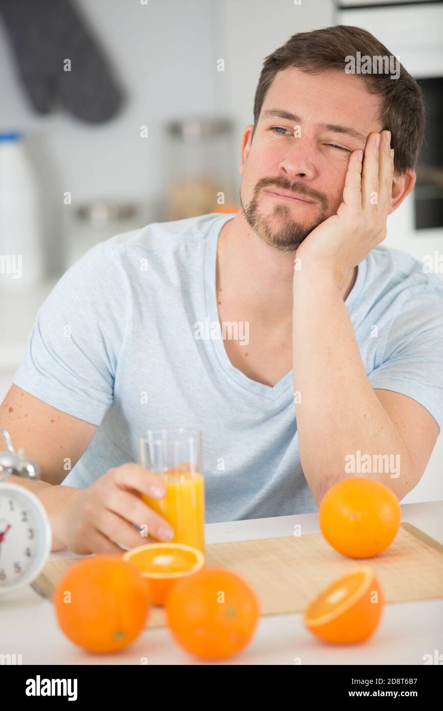man eating breakfast in the morning half sleepy Stock Photo - Alamy