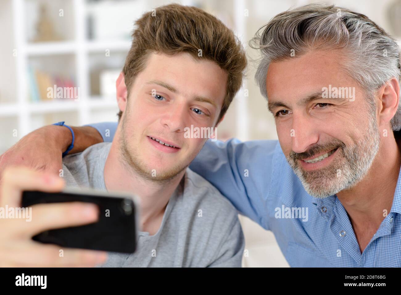 two men with a smartphone Stock Photo - Alamy