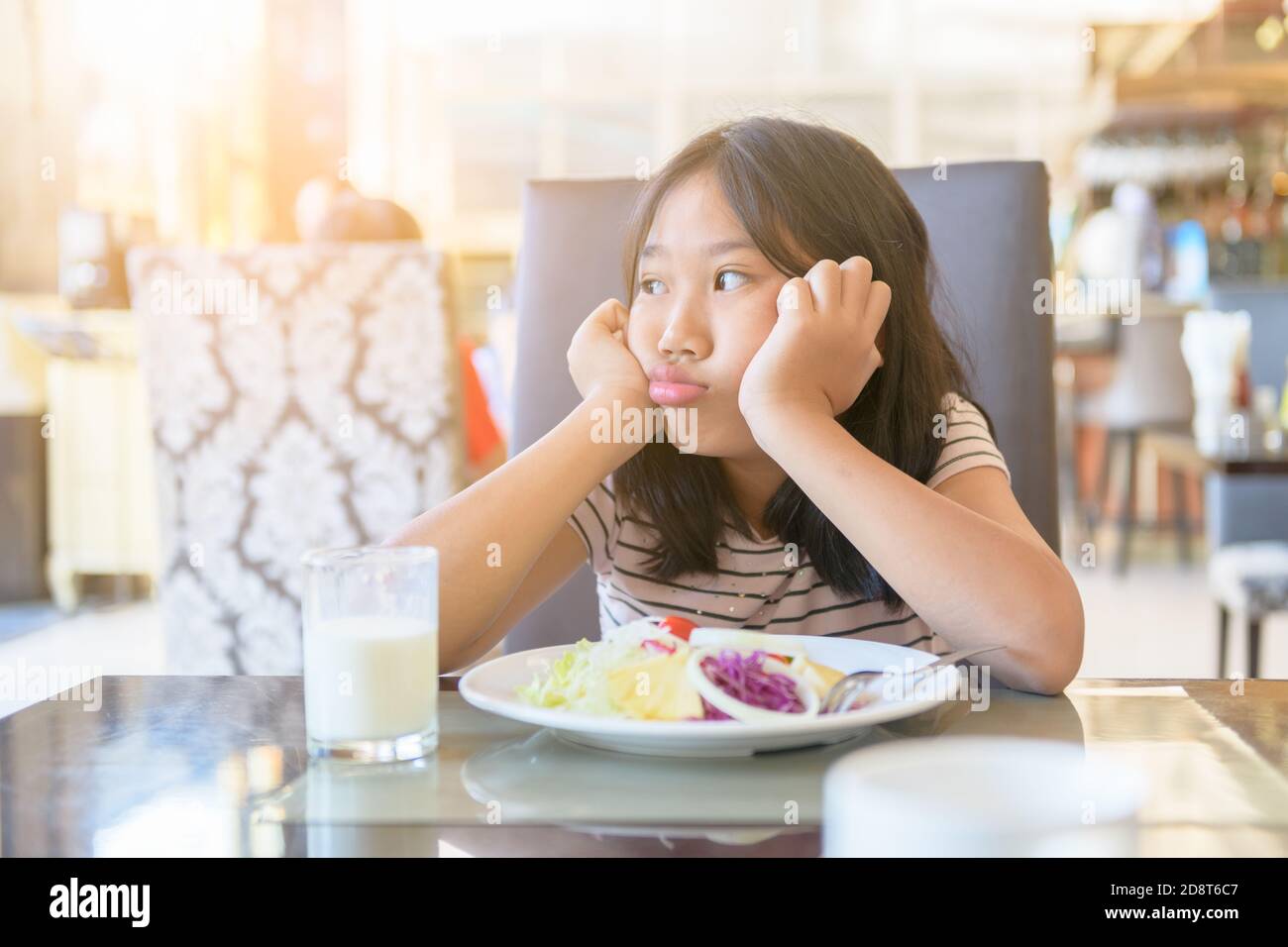 asian child girl with expression of disgust against vegetables in ...