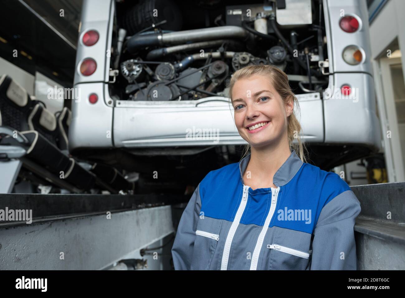 portrait of smiling mechanic adjusting tire Stock Photo - Alamy