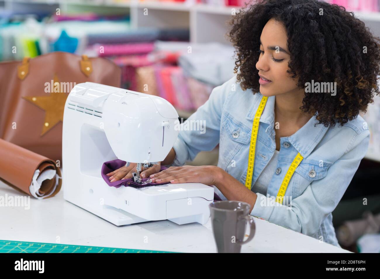 young woman sewing with sewing machine Stock Photo - Alamy