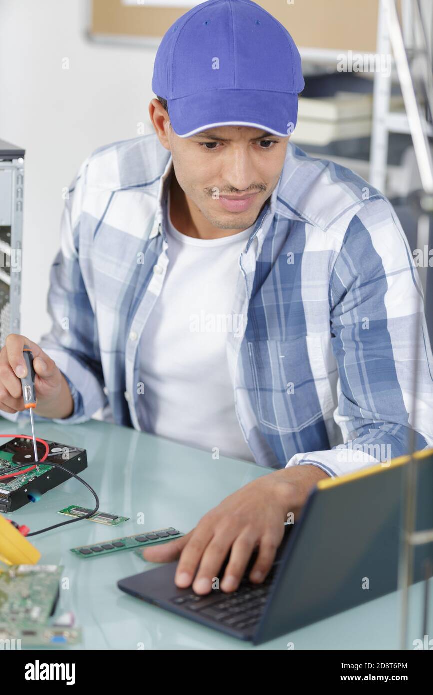 engineer checking laptop while holding hd in hands Stock Photo - Alamy