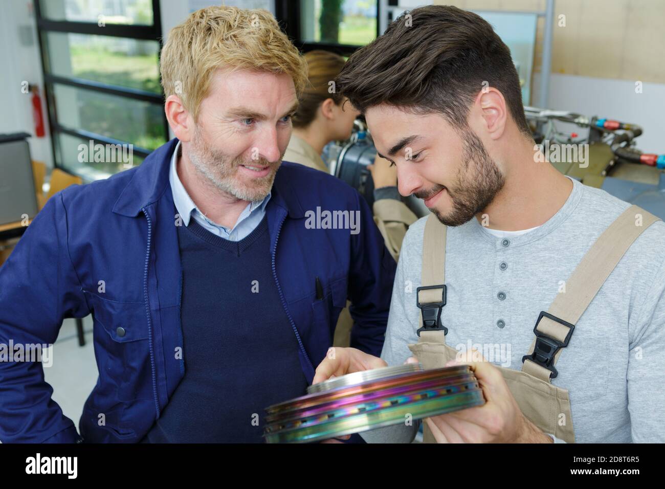 two men in the production of something Stock Photo - Alamy