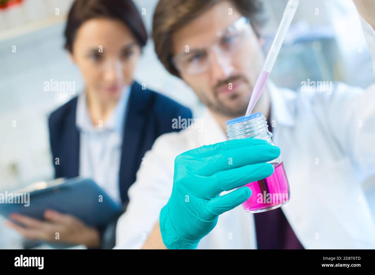young chemist at work mixing liquids in lab Stock Photo - Alamy