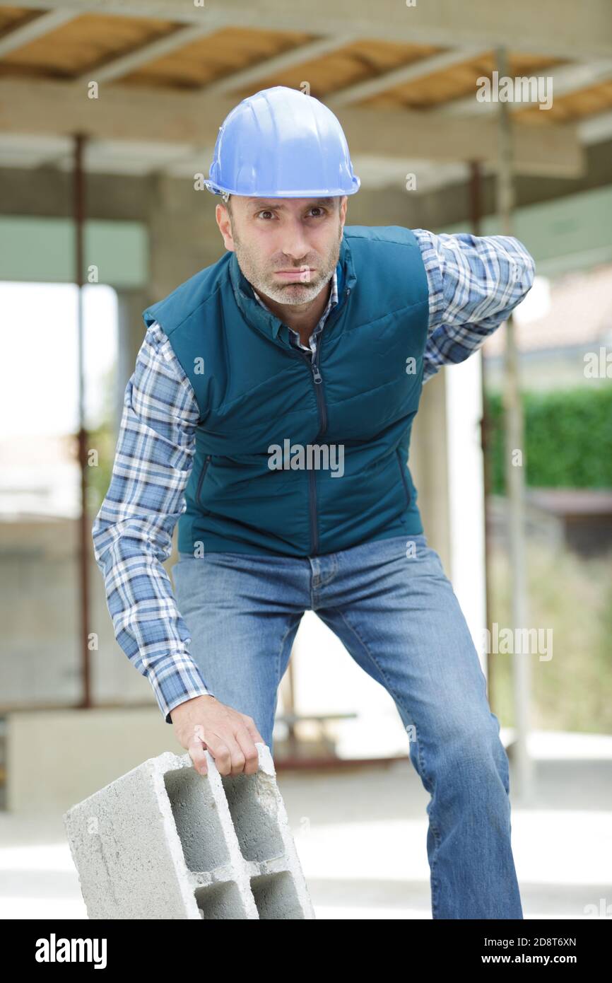 builder has hurt back after a lifting injury Stock Photo - Alamy