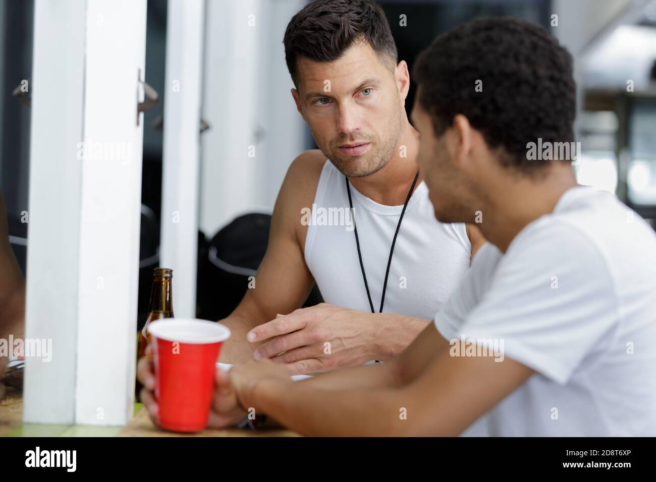 men drinking beer after exercising Stock Photo - Alamy