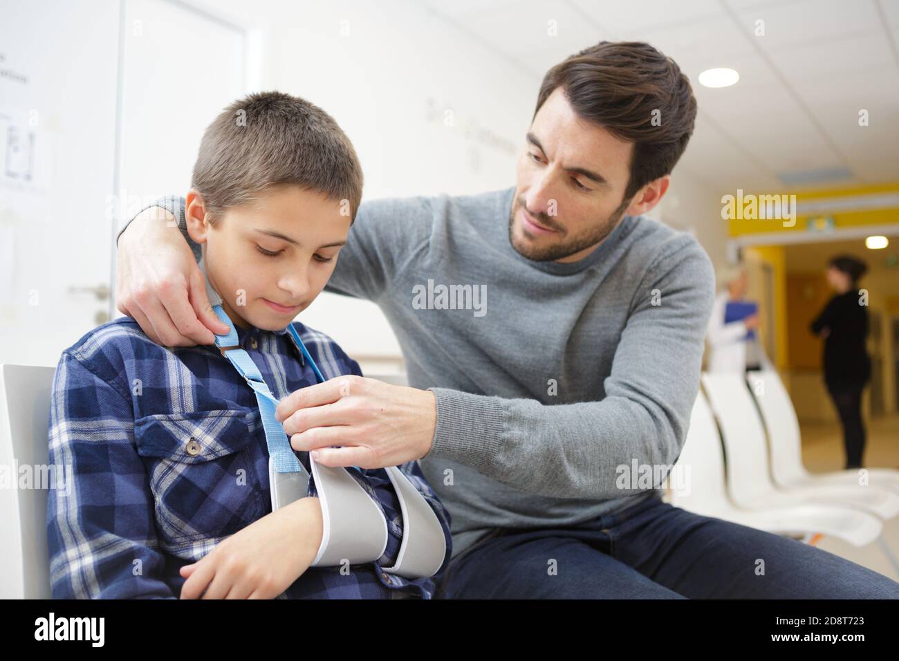 man taking care of a boy Stock Photo - Alamy