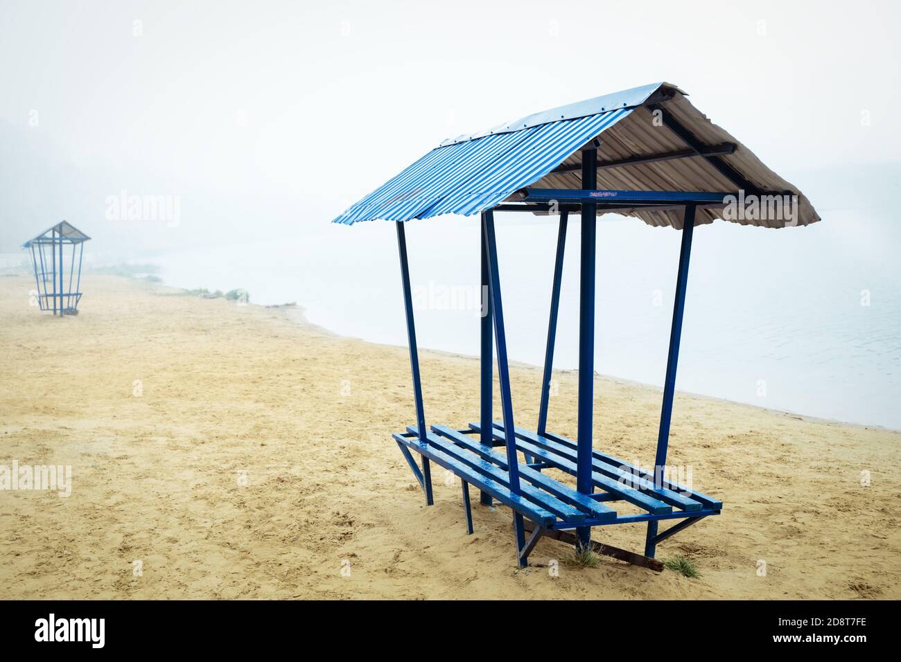 Blue benches on beach in fog Stock Photo - Alamy