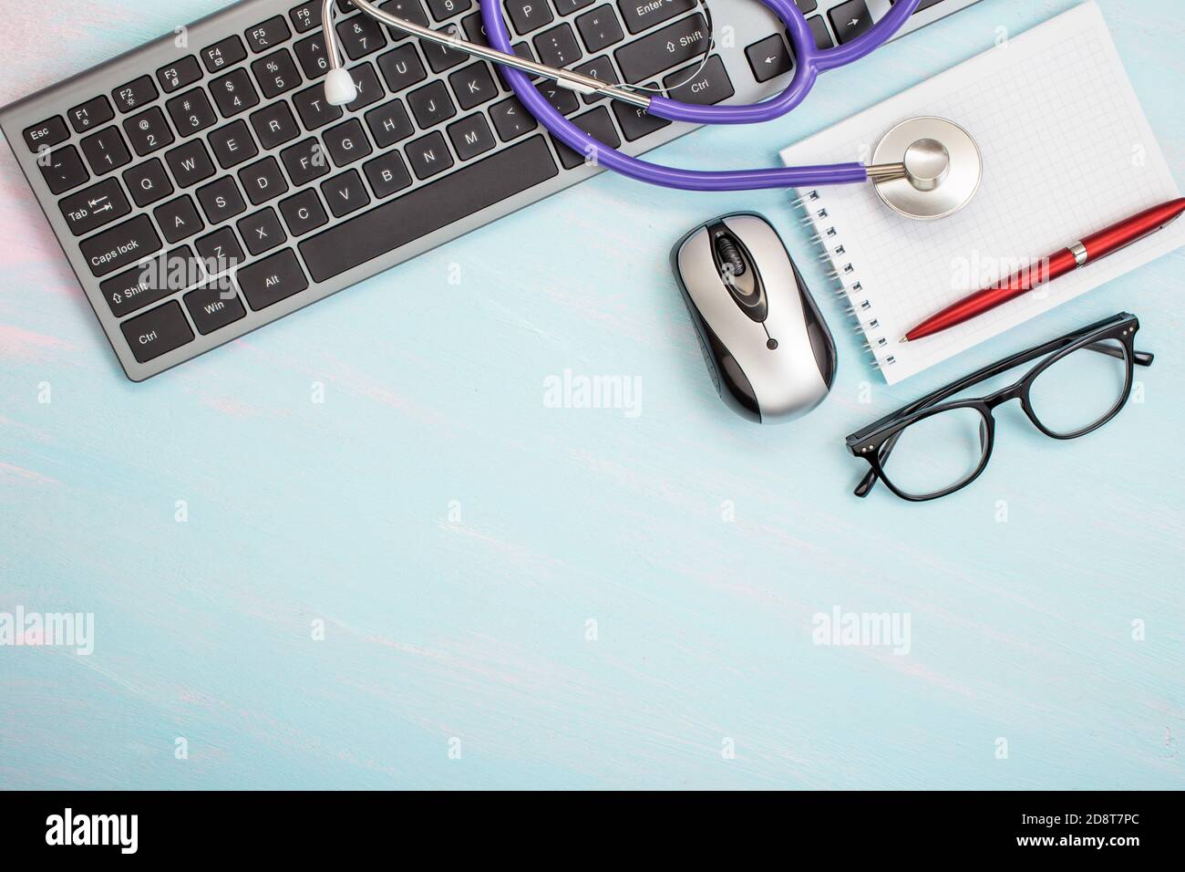 Blue doctors desk with various items Stock Photo - Alamy