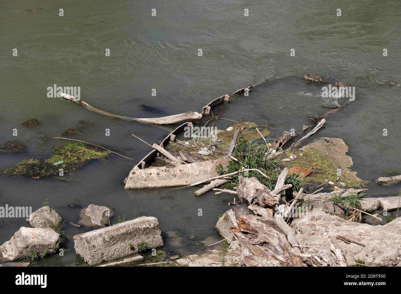Boat wreck in Tiber river in Rome, Italy, sunken and partially covered ...