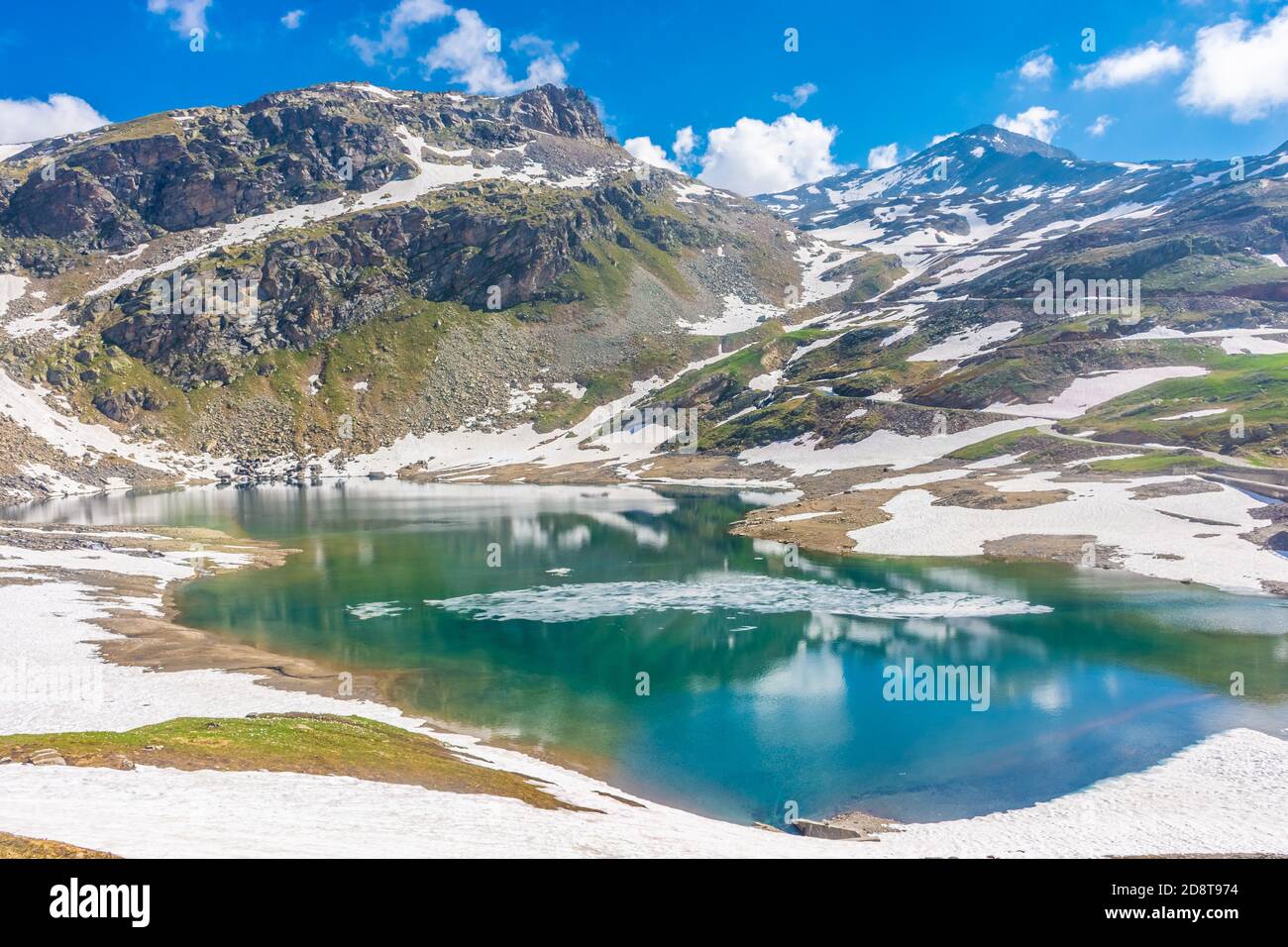 Beautiful emerald Alpine Lake in the snowy landscape in Gran Paradiso ...