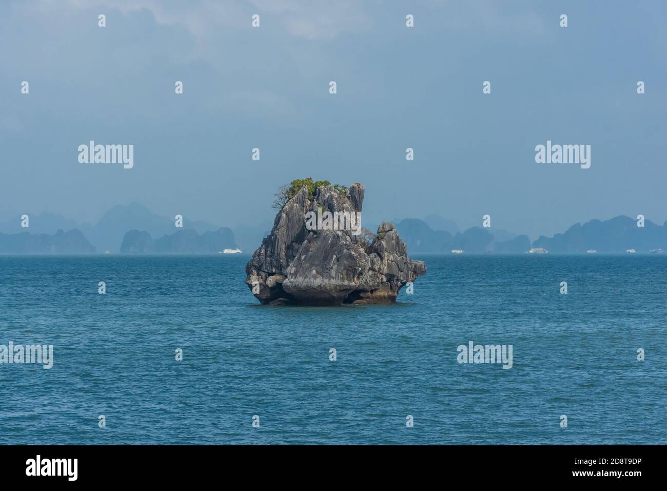 Lonely sea stack in Ha Long Bay, Vietnam Stock Photo - Alamy