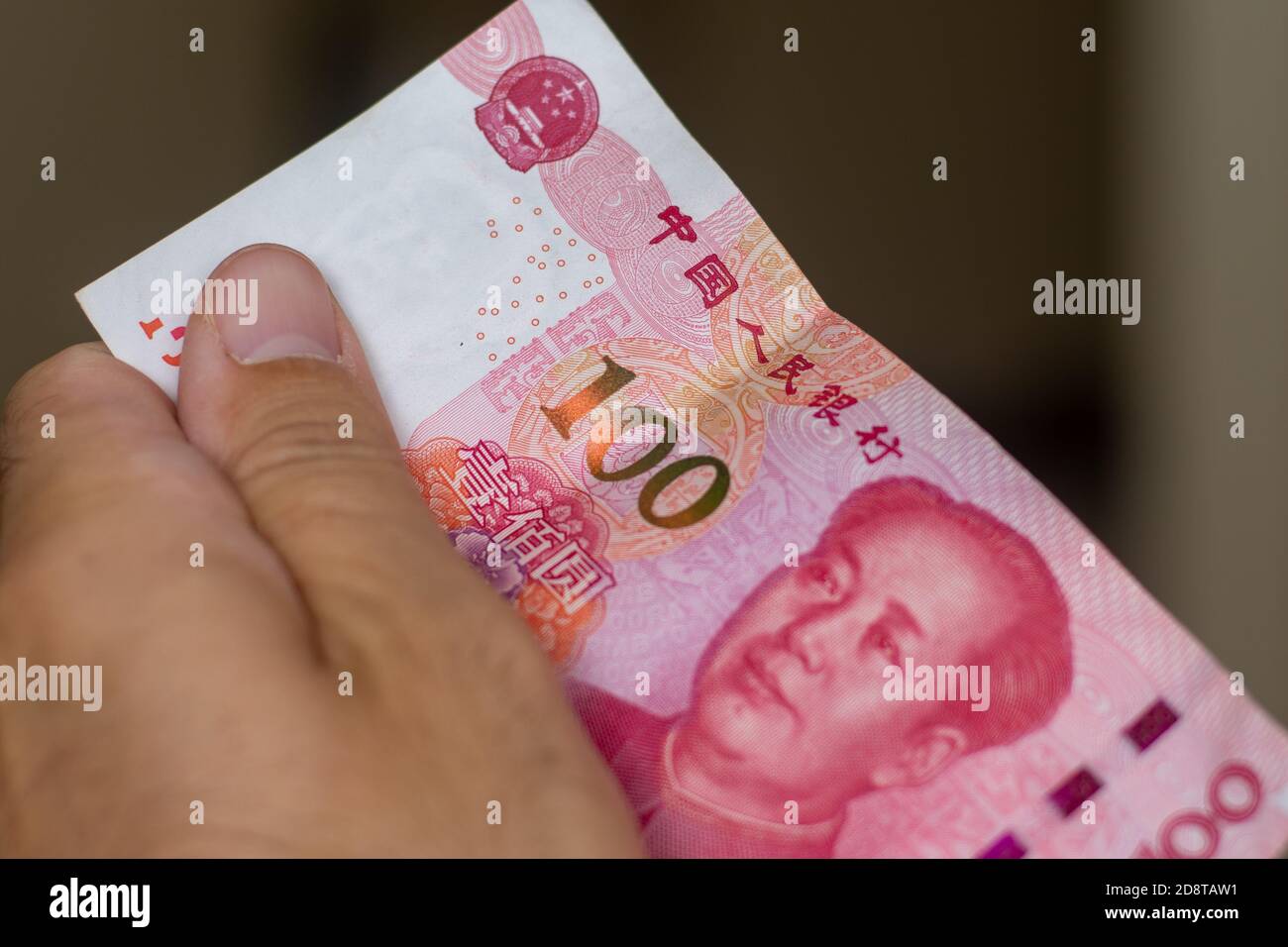Persons hand giving the Currency of the China - One red hundred ...