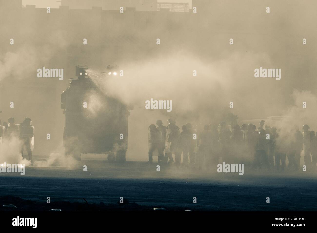Military police riot response to a protest with tear gas, smoke, fire ...