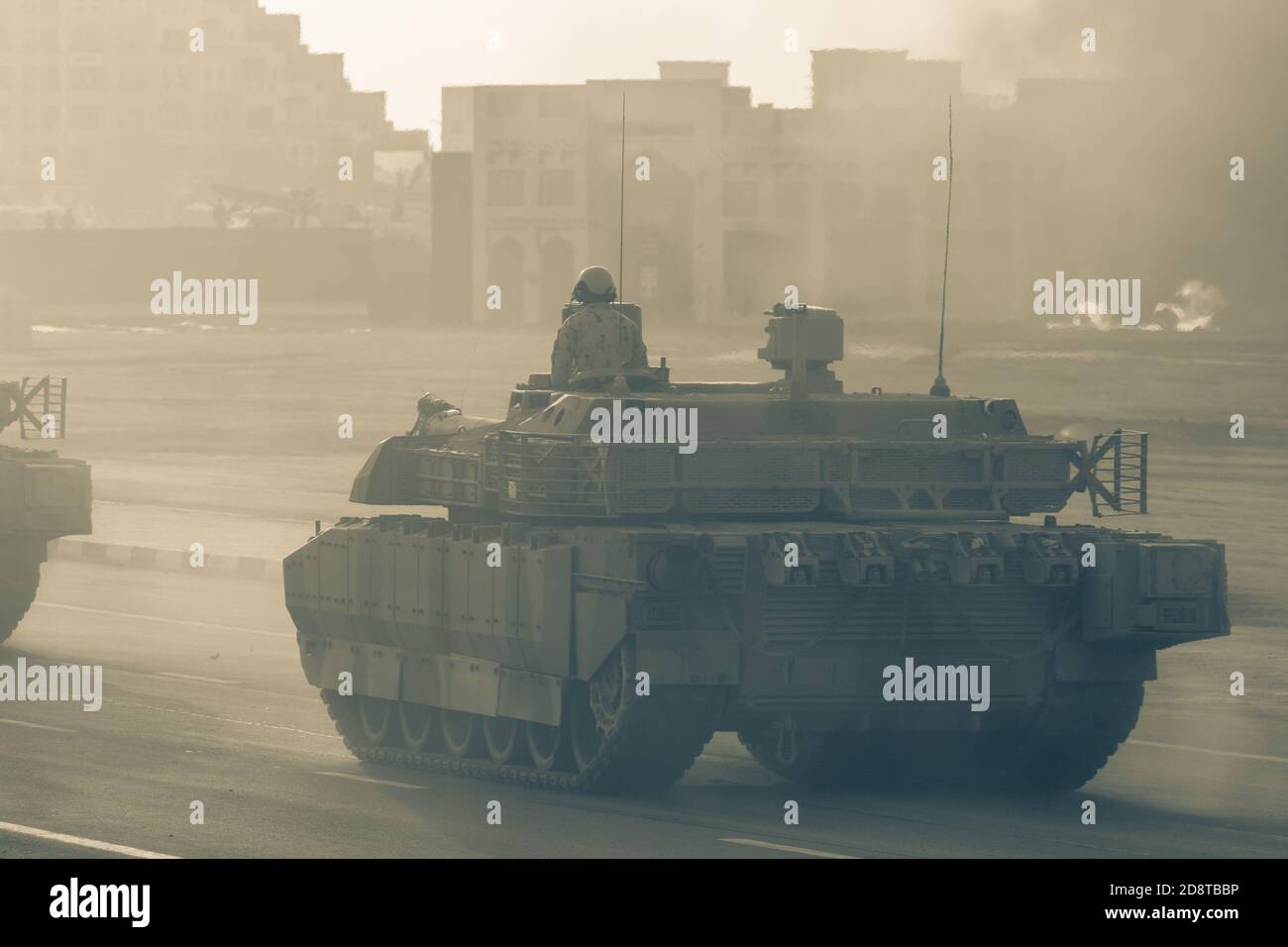 Military army tank vehicles driving down the road with guns and ...