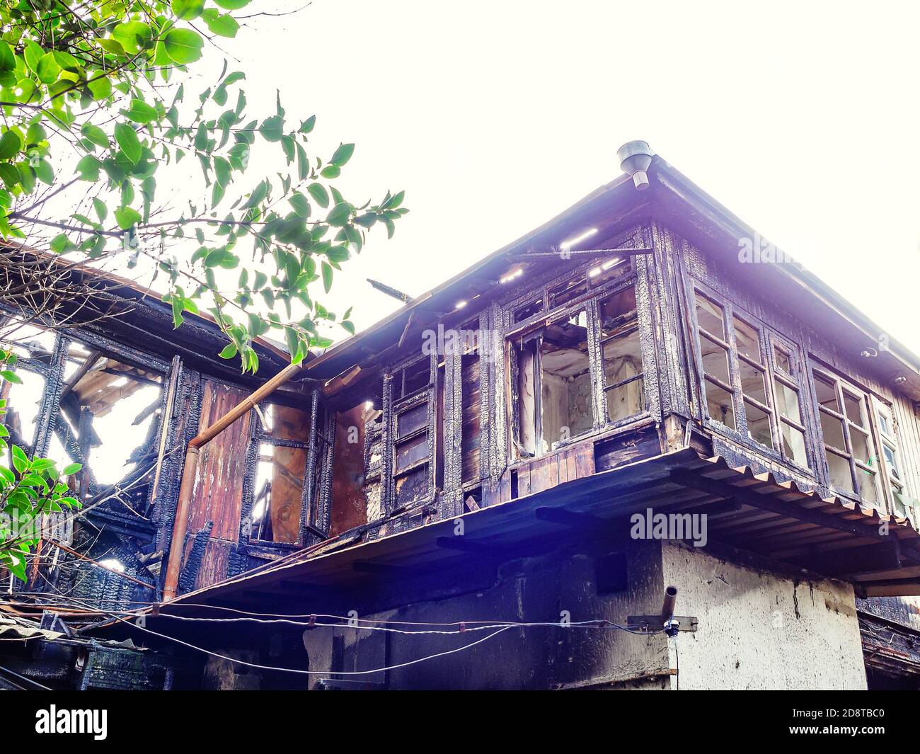 Burnt old destroyed wooden house with frames without glass on the ...