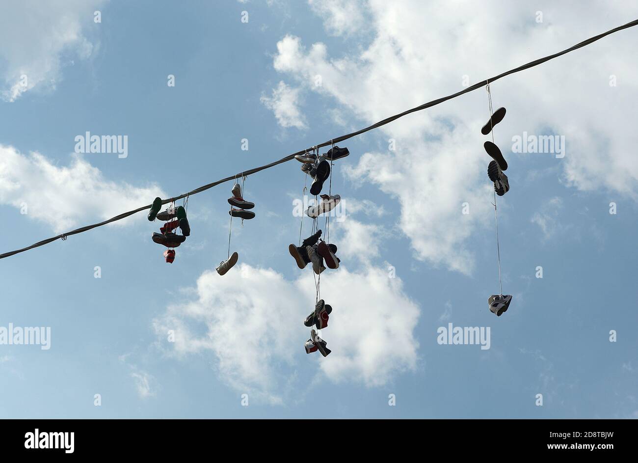 Shoes hanging from light hi-res stock photography and images - Alamy